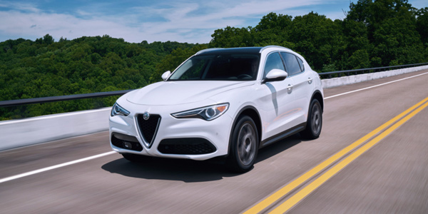 White 2020 Alfa Romeo Stelvio being driven fast on the road