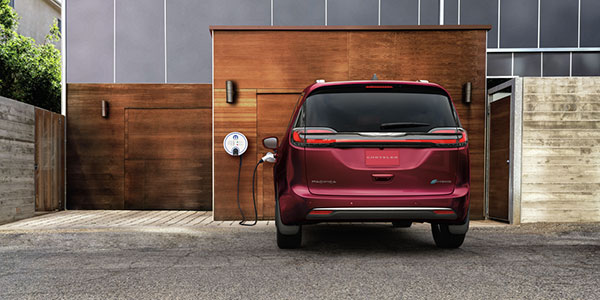 Back view of a red 2023 Chrysler Pacifica Hybrid PHEV parked at an ...