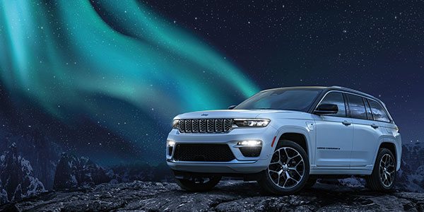 A three-quarter profile view of a silver Grand Cherokee 4xe PHEV is ...